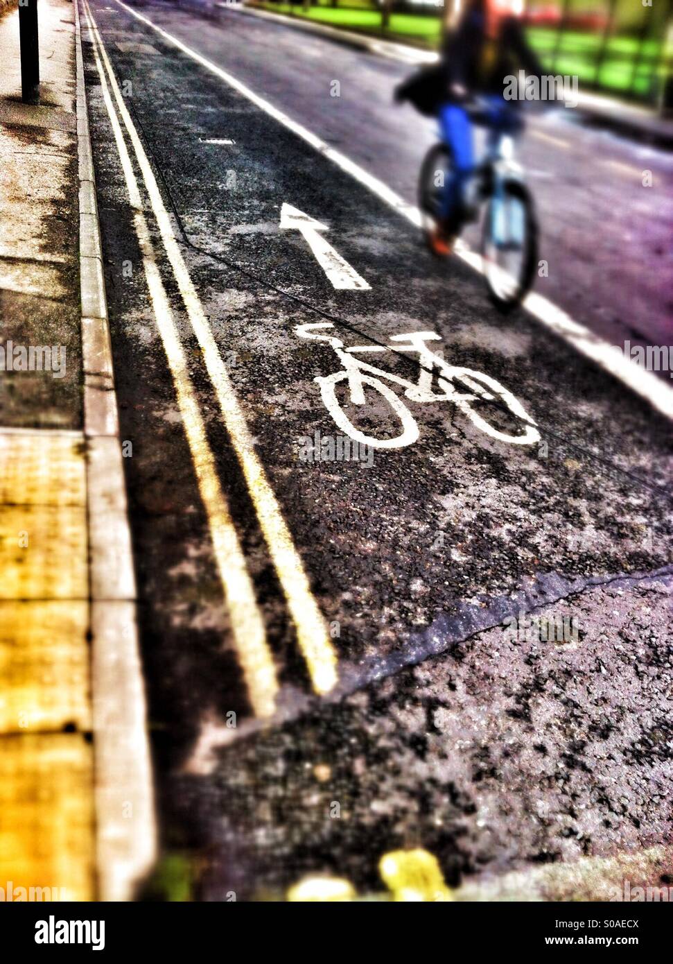Cycling sign and blurred cyclist England UK Stock Photo - Alamy