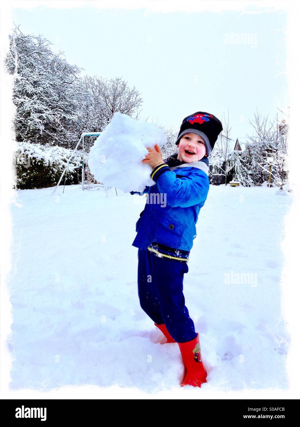 Boy with snowman hi-res stock photography and images - Alamy