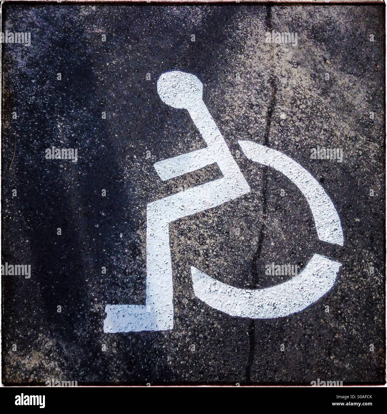 White disabled sign painted on asphalt Stock Photo - Alamy