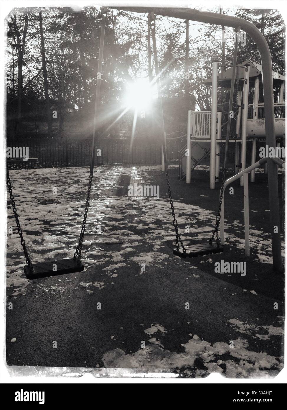 Sun shining on swings Stock Photo - Alamy