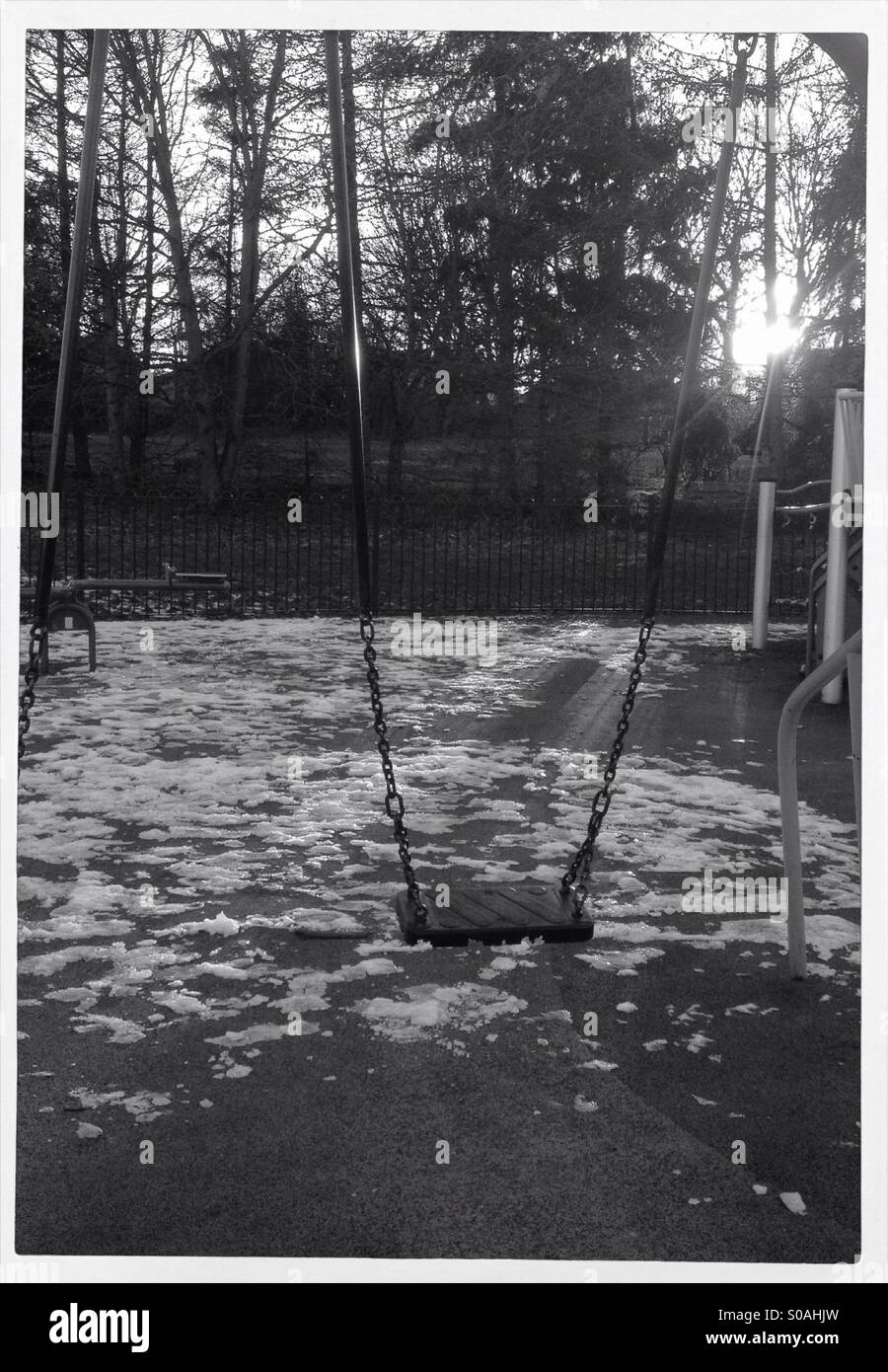 Sun shining on swing Stock Photo - Alamy