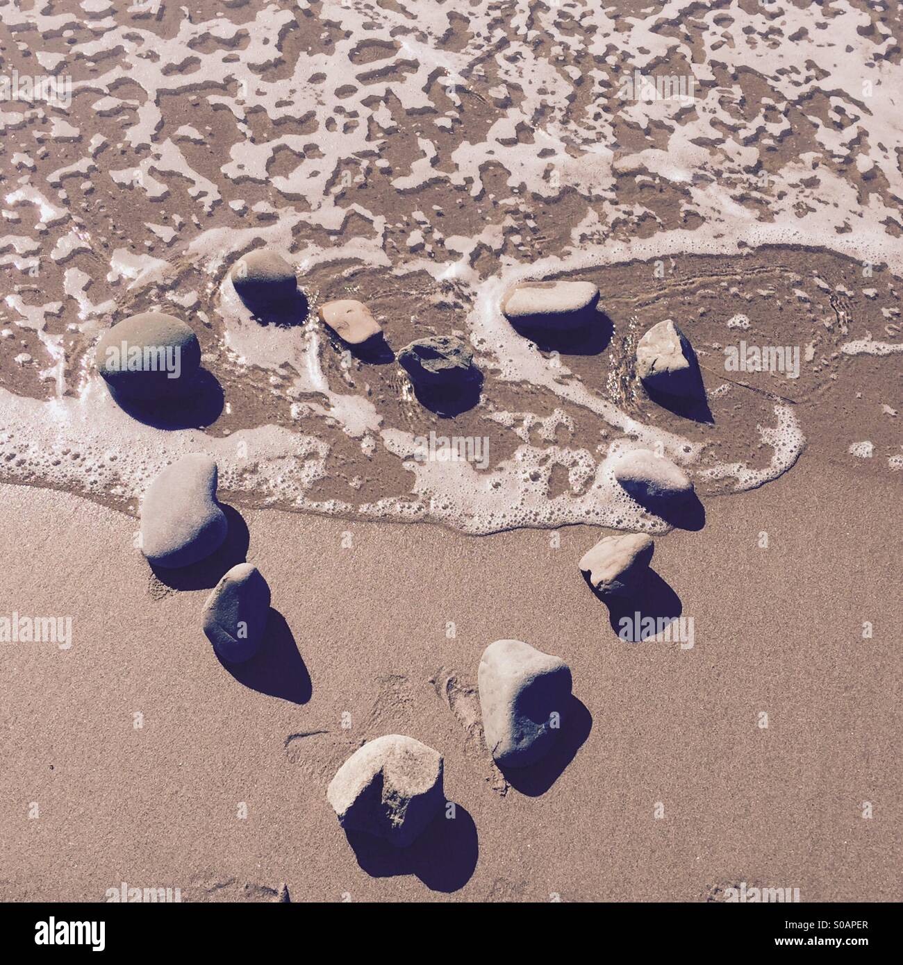 Heart shape rocks beach sand hi-res stock photography and images - Alamy