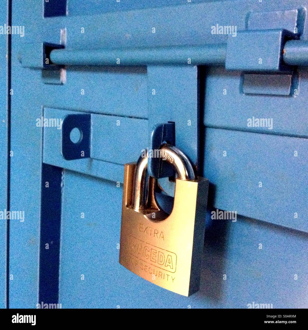 Brass lock on blue door Stock Photo - Alamy