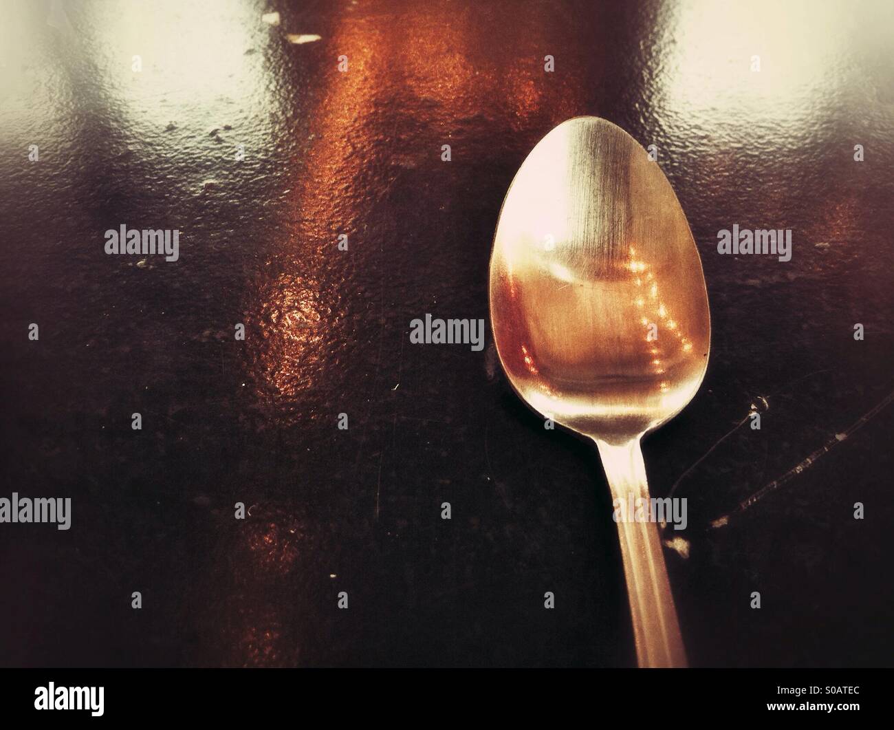 metal spoon on a table reflecting string of lights Stock Photo - Alamy