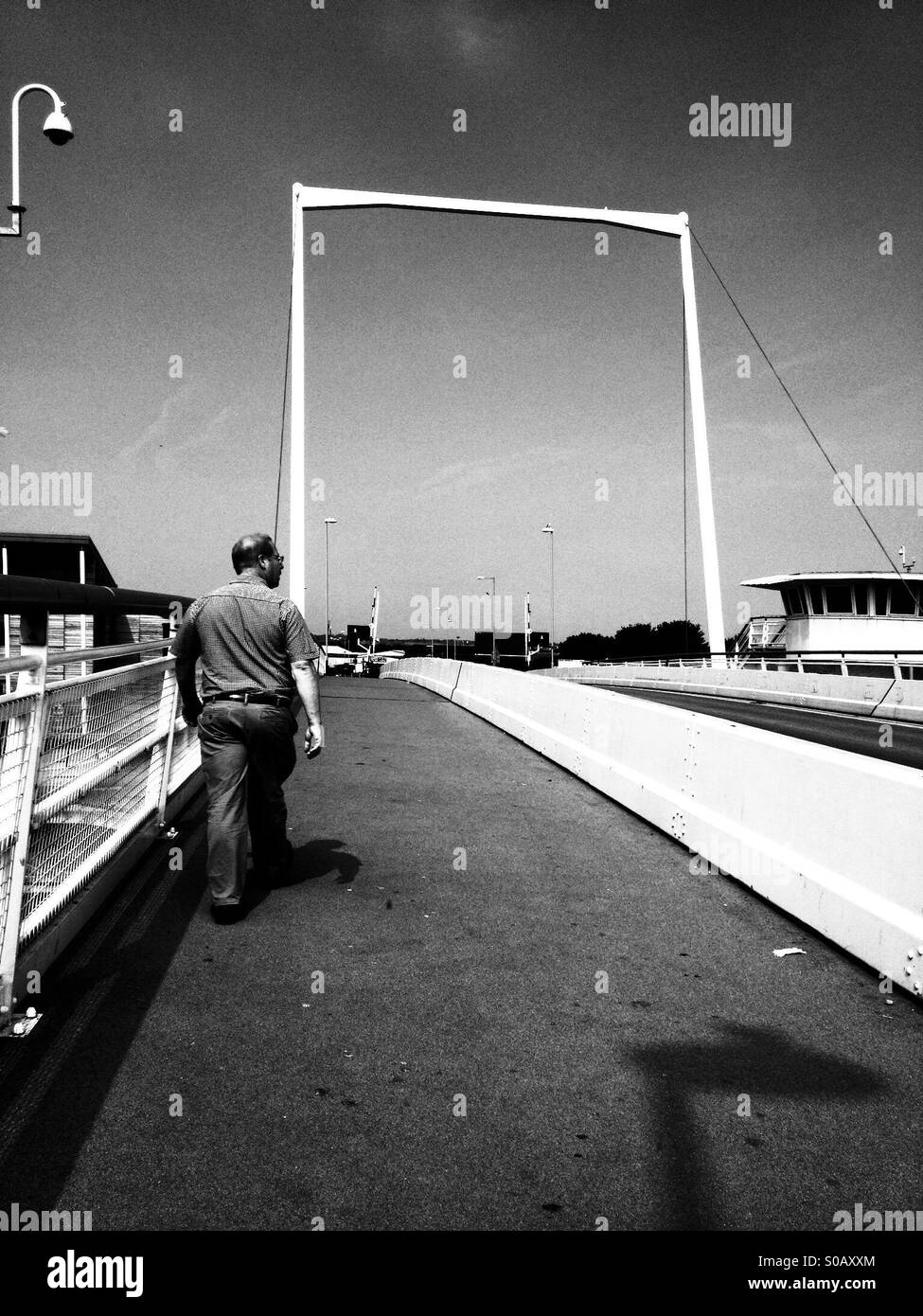 Man walking over a bridge hi-res stock photography and images - Alamy