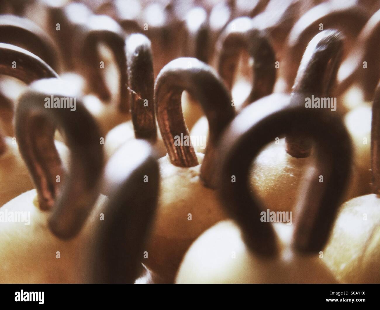 Macro image of copper loops sticking out of the golden beads in ...
