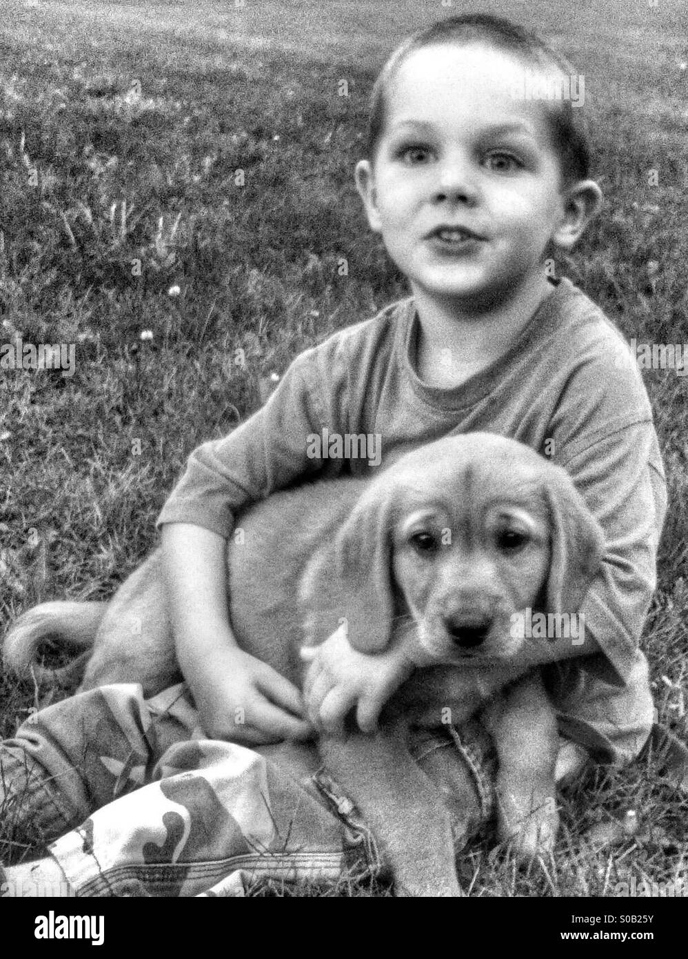 Boy with puppy Black and White Stock Photos & Images - Alamy