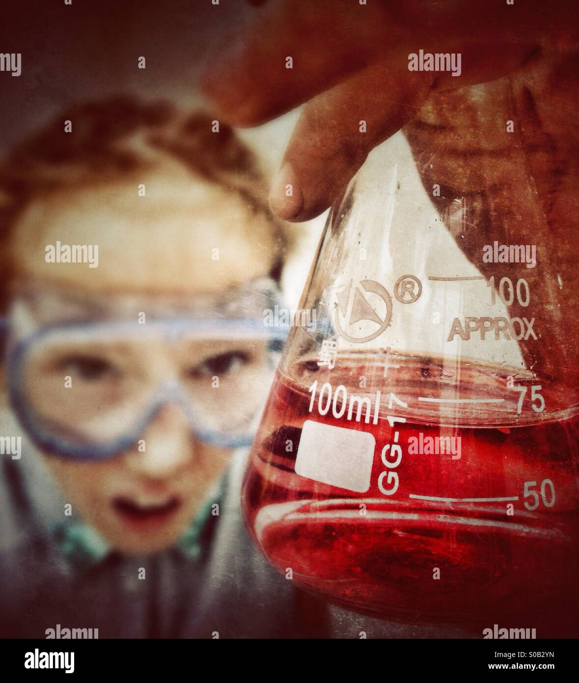 Young girl wearing goggles to carry out chemistry experiment Stock ...