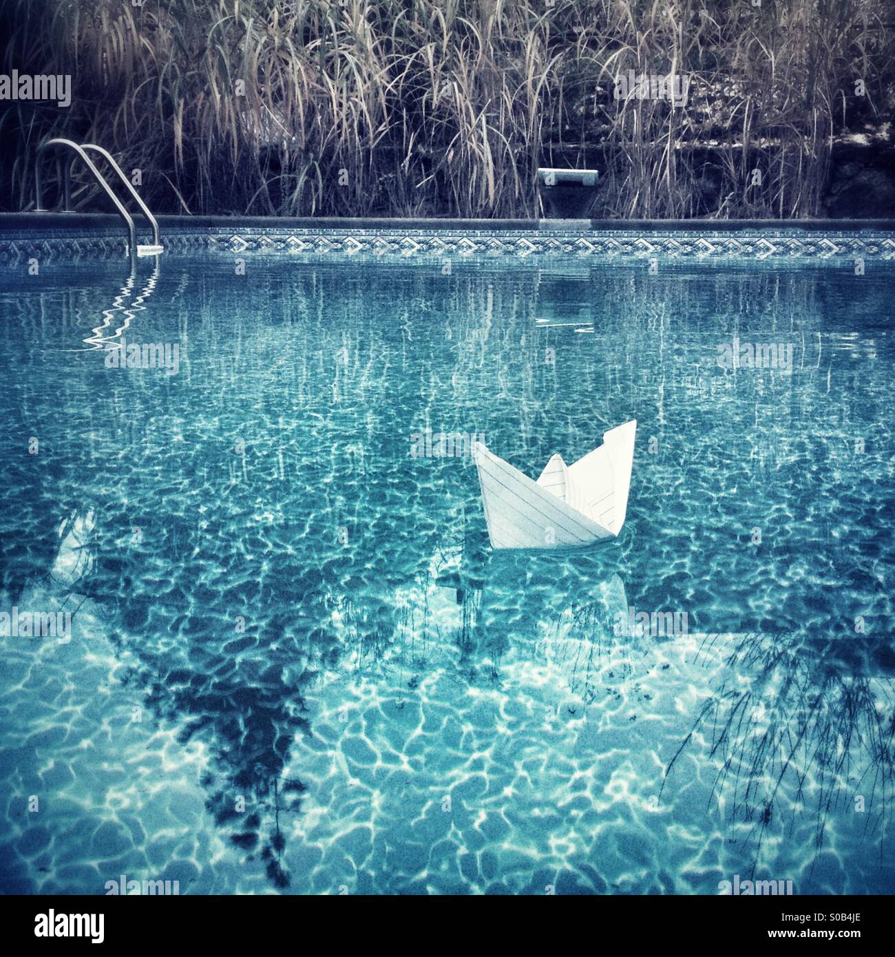 Paper boat floating in a swimming pool on a cool autumn day Stock Photo ...