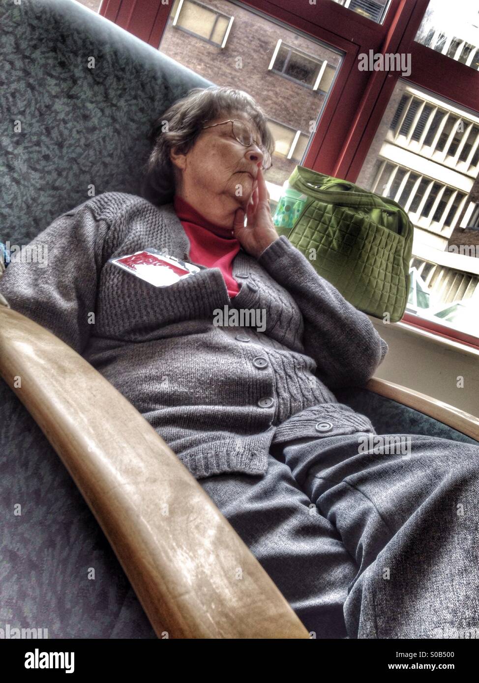 A senior lady resting while visiting an ICU patient Stock Photo - Alamy