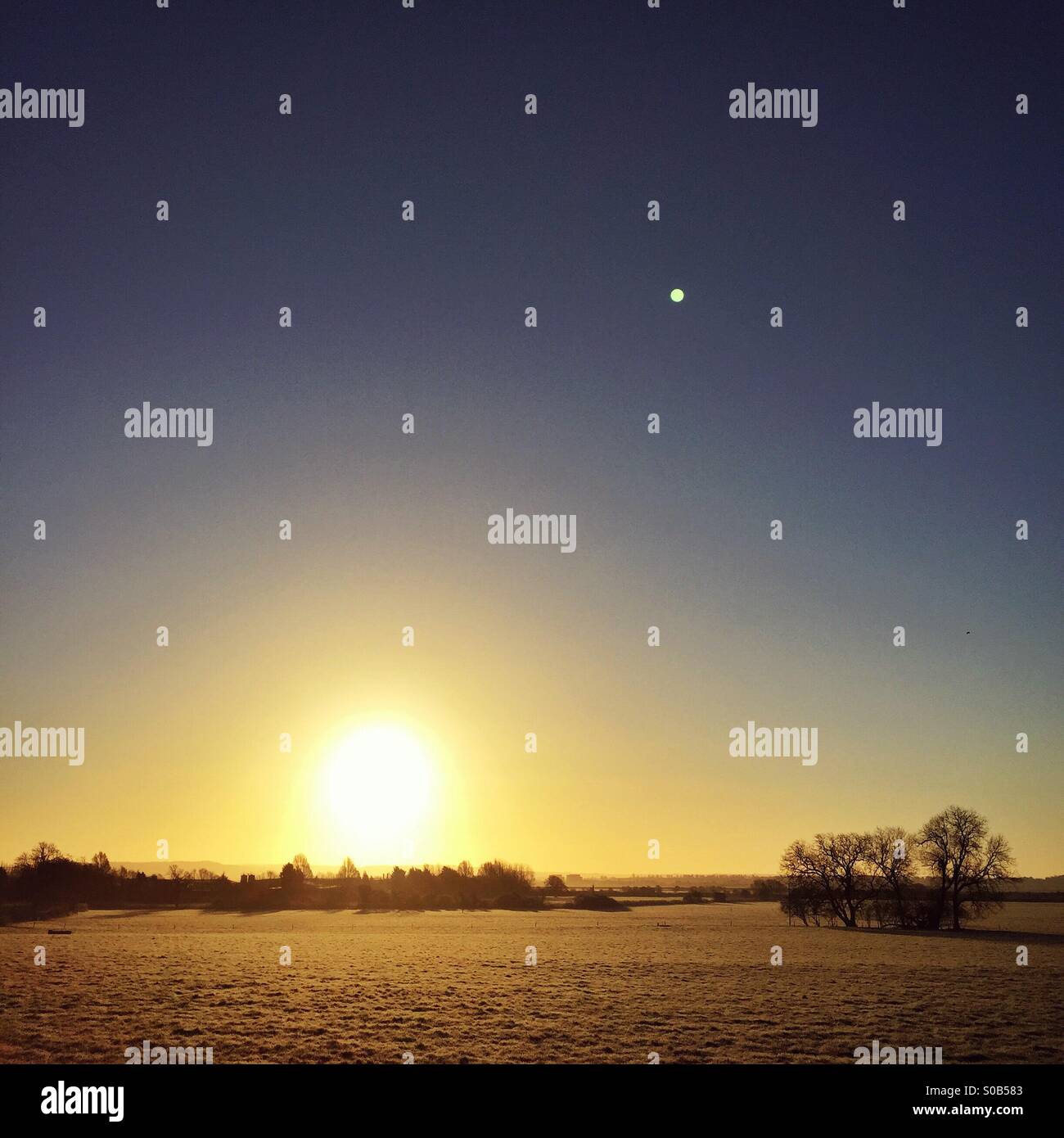 Sunrise over farmland Stock Photo - Alamy