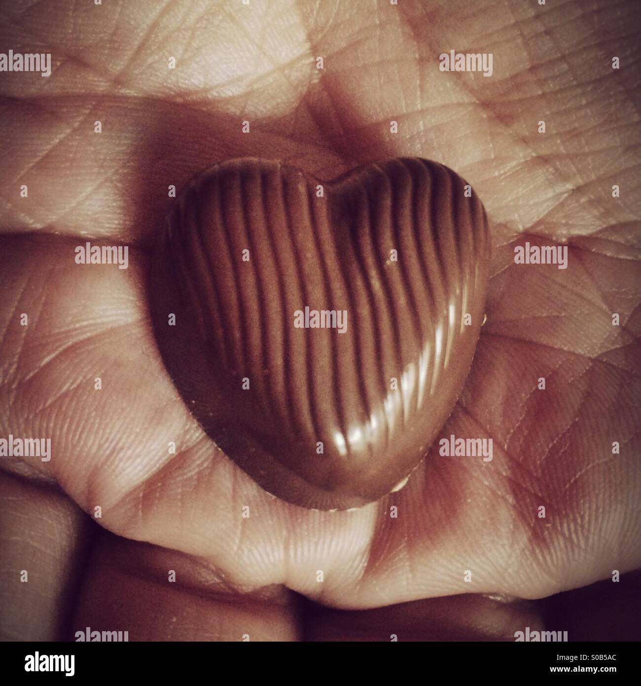 Chocolate in hand palm hi-res stock photography and images - Alamy