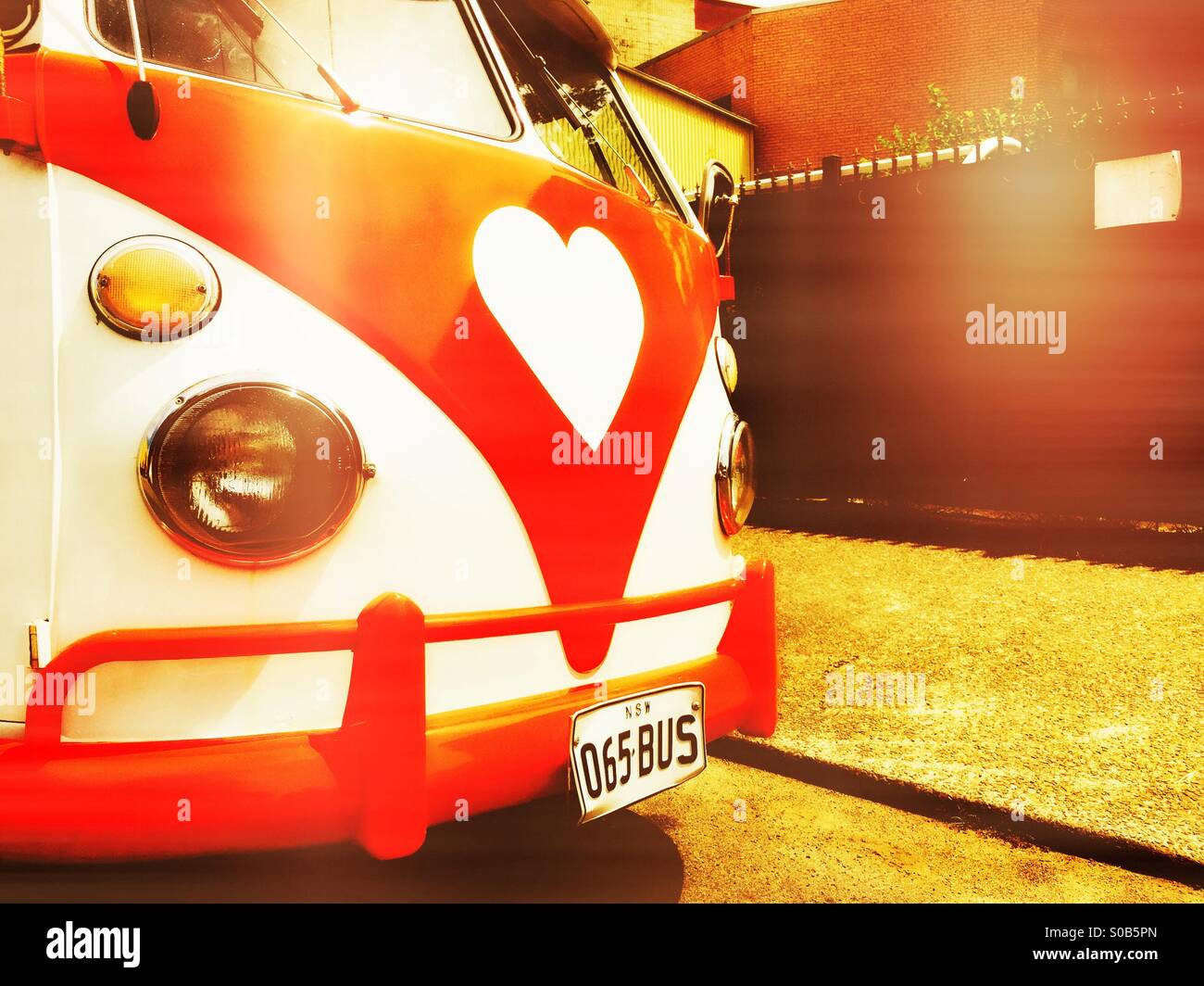 An old VW bus with a heart logo on the front Stock Photo - Alamy