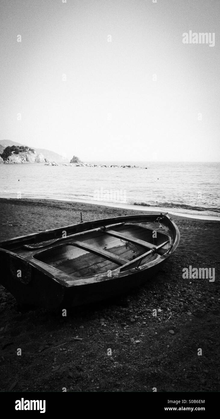 A small row boat beached along the Mediterranean Sea Stock Photo - Alamy