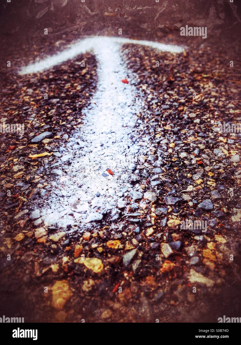 Painted arrow on the ground pointing to a direction Stock Photo - Alamy
