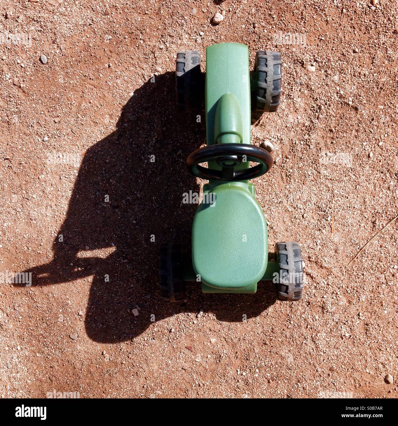 Toy tractor with shadow Stock Photo - Alamy