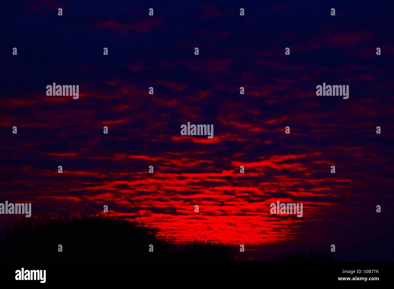 Blood red sunset on a Sky of clouds Stock Photo - Alamy
