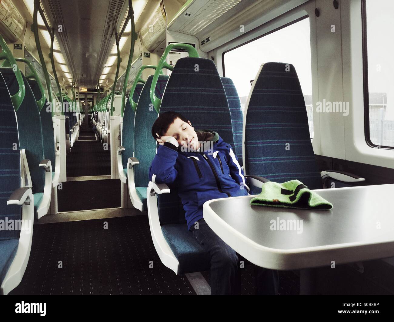 Child sleeping on a train Stock Photo - Alamy