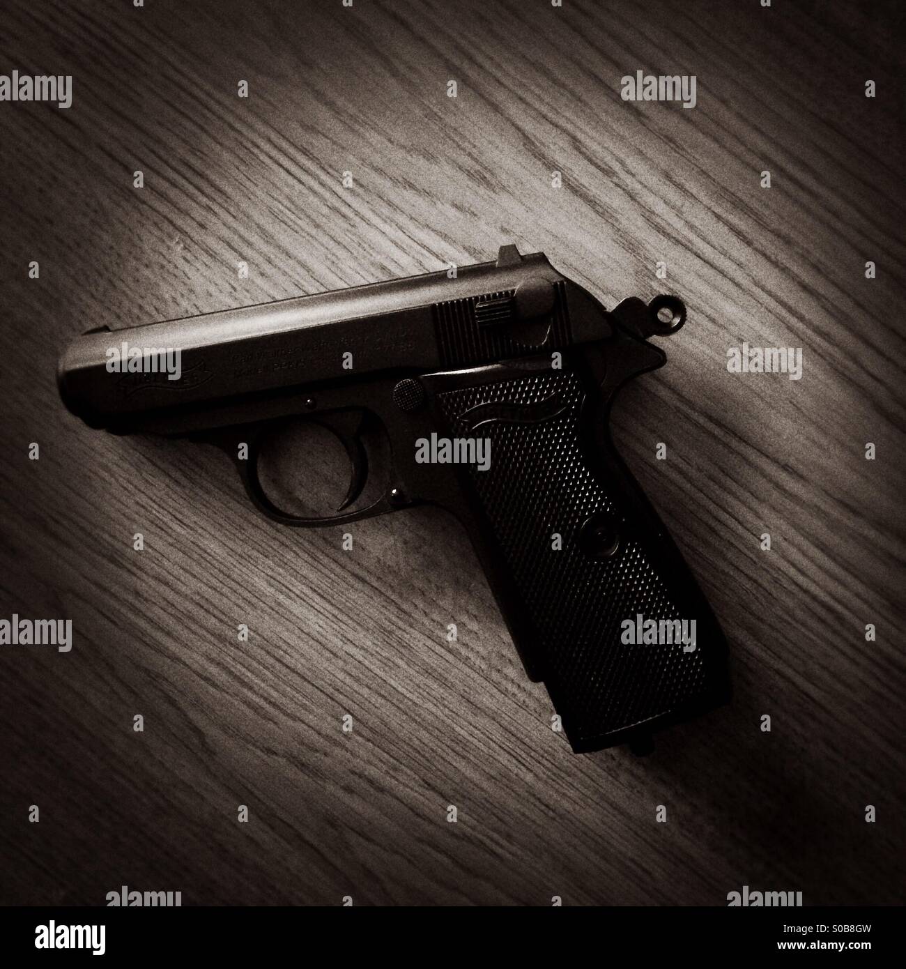 Handgun on wooden table Stock Photo - Alamy