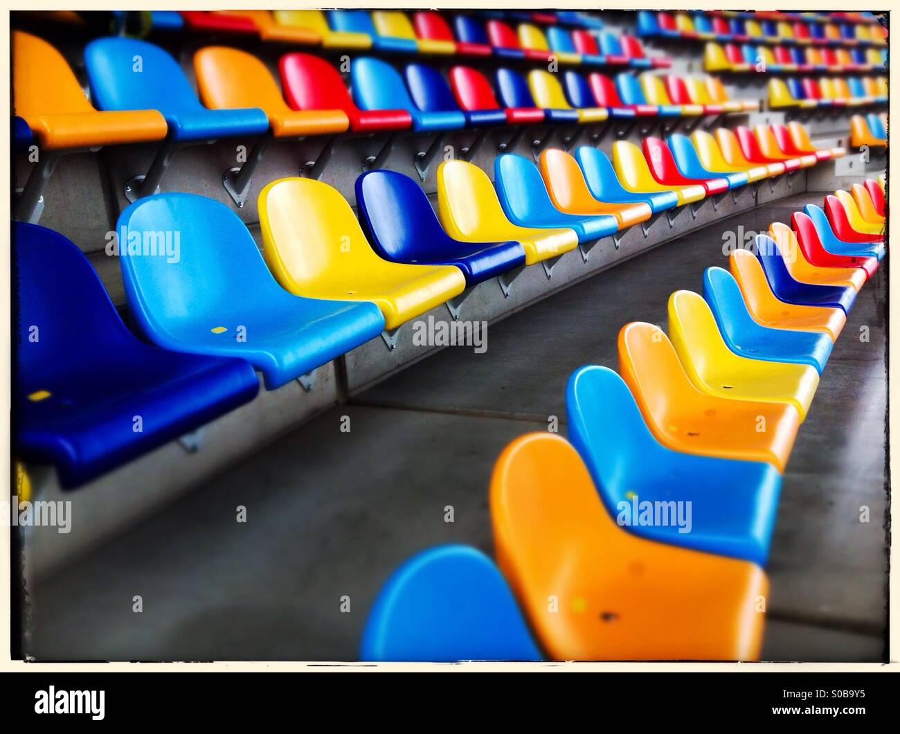 Emtpy colorful seats in a stadium Stock Photo - Alamy