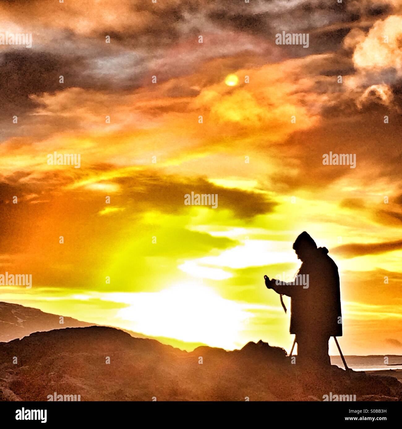 Photographer getting ready to photograph the dramatic sunset Stock ...