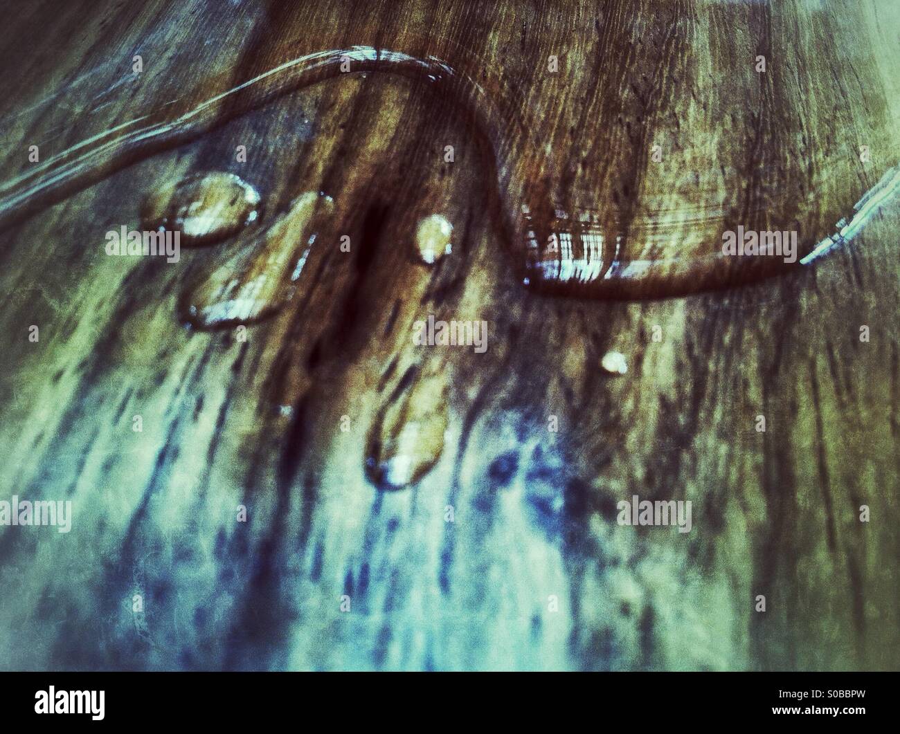 Spilled water on wooden table Stock Photo - Alamy