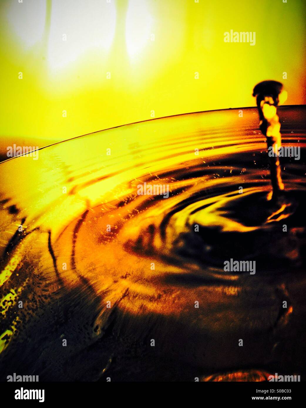 Water drop with a colourful background Stock Photo - Alamy