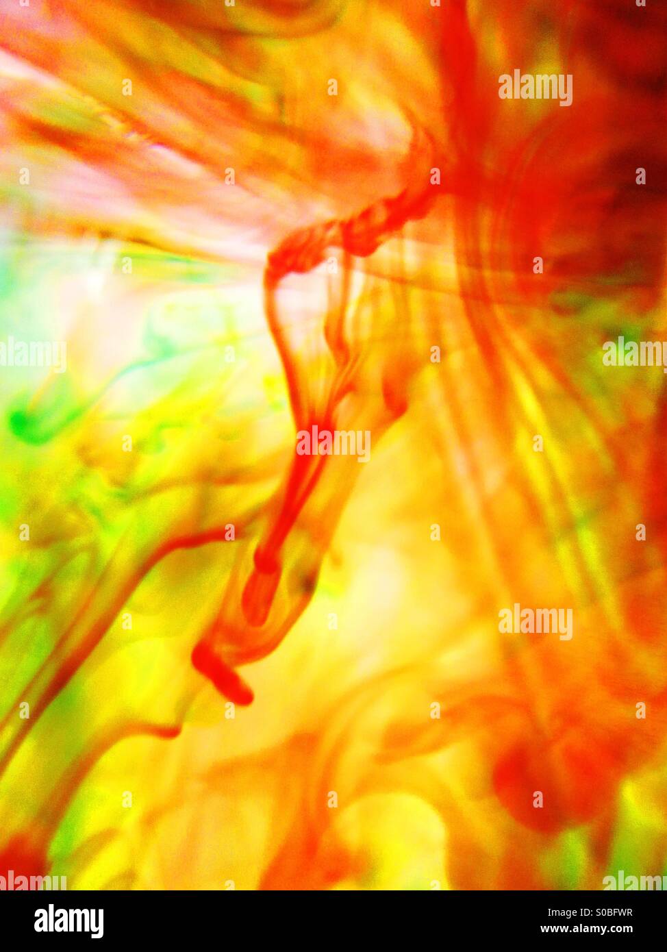 Different colored dye floating in water Stock Photo - Alamy