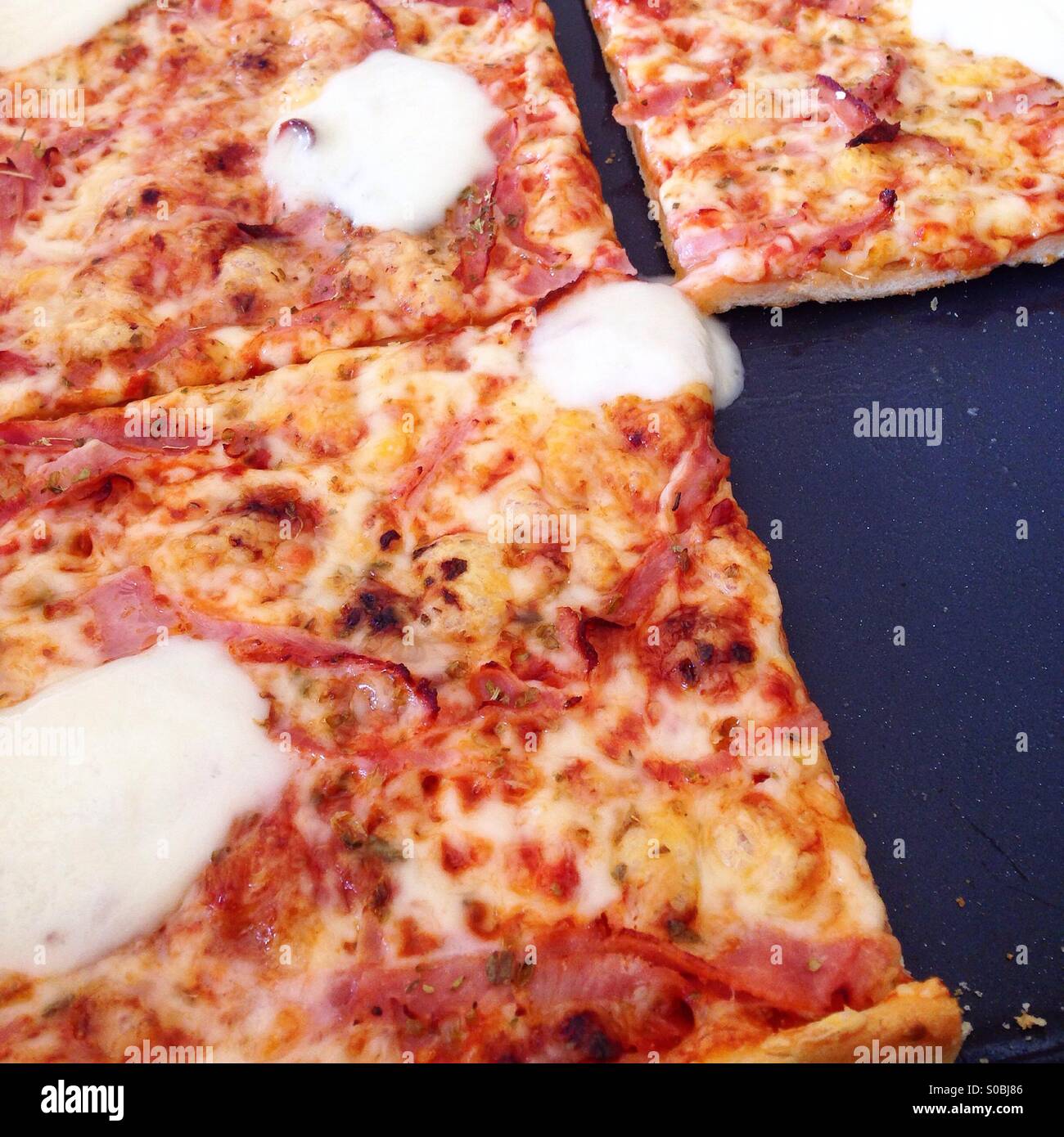 Homemade pizza with ham and mozzarella cheese Stock Photo - Alamy