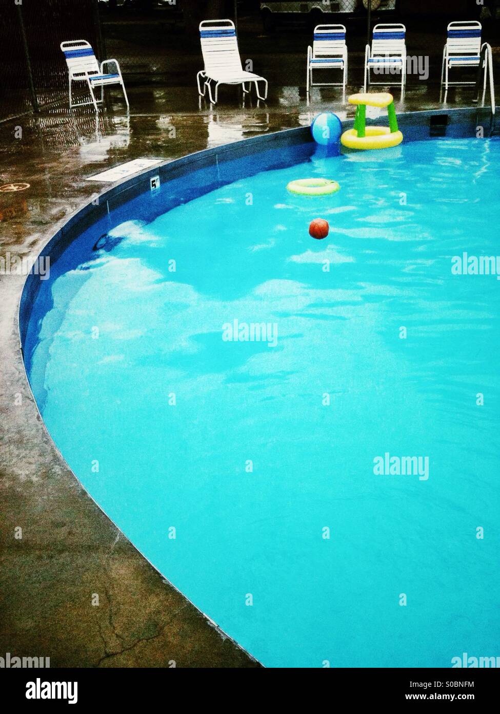 Empty pool on a rainy day Stock Photo - Alamy