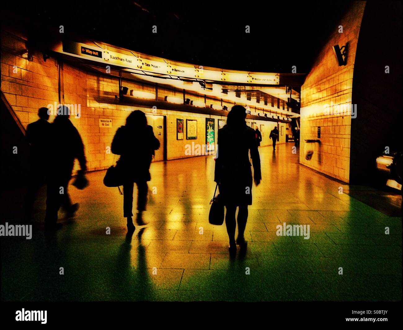 Commuters inside tube tunnel, Southwark underground station, London ...