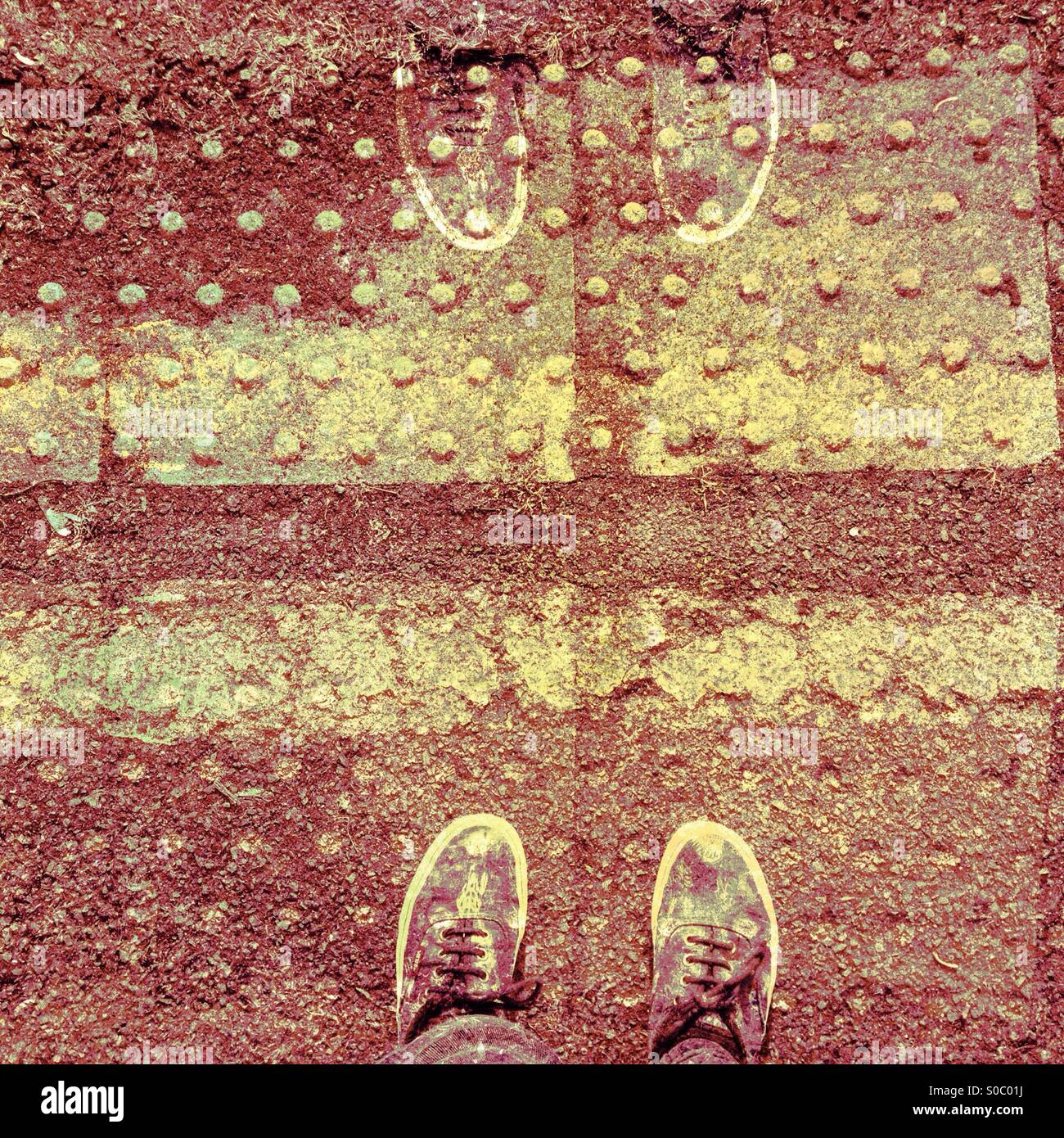 Standing behind the yellow lines Stock Photo - Alamy