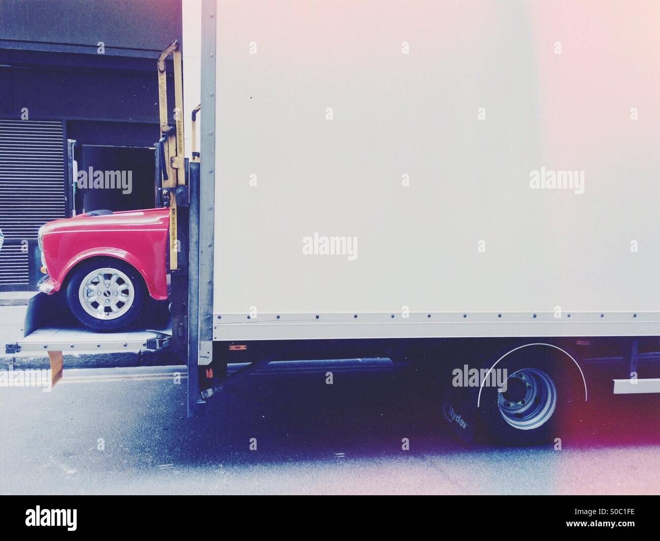 Auditing Mini motor car being delivered out of the back of a lorry ...