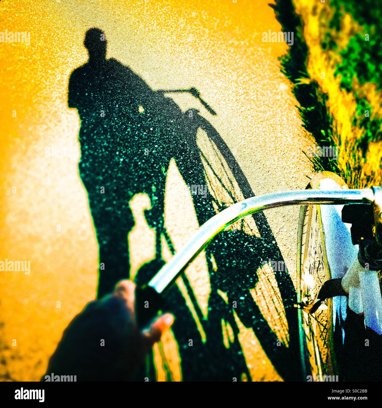 A shadow of a bike rider on a bike path Stock Photo - Alamy