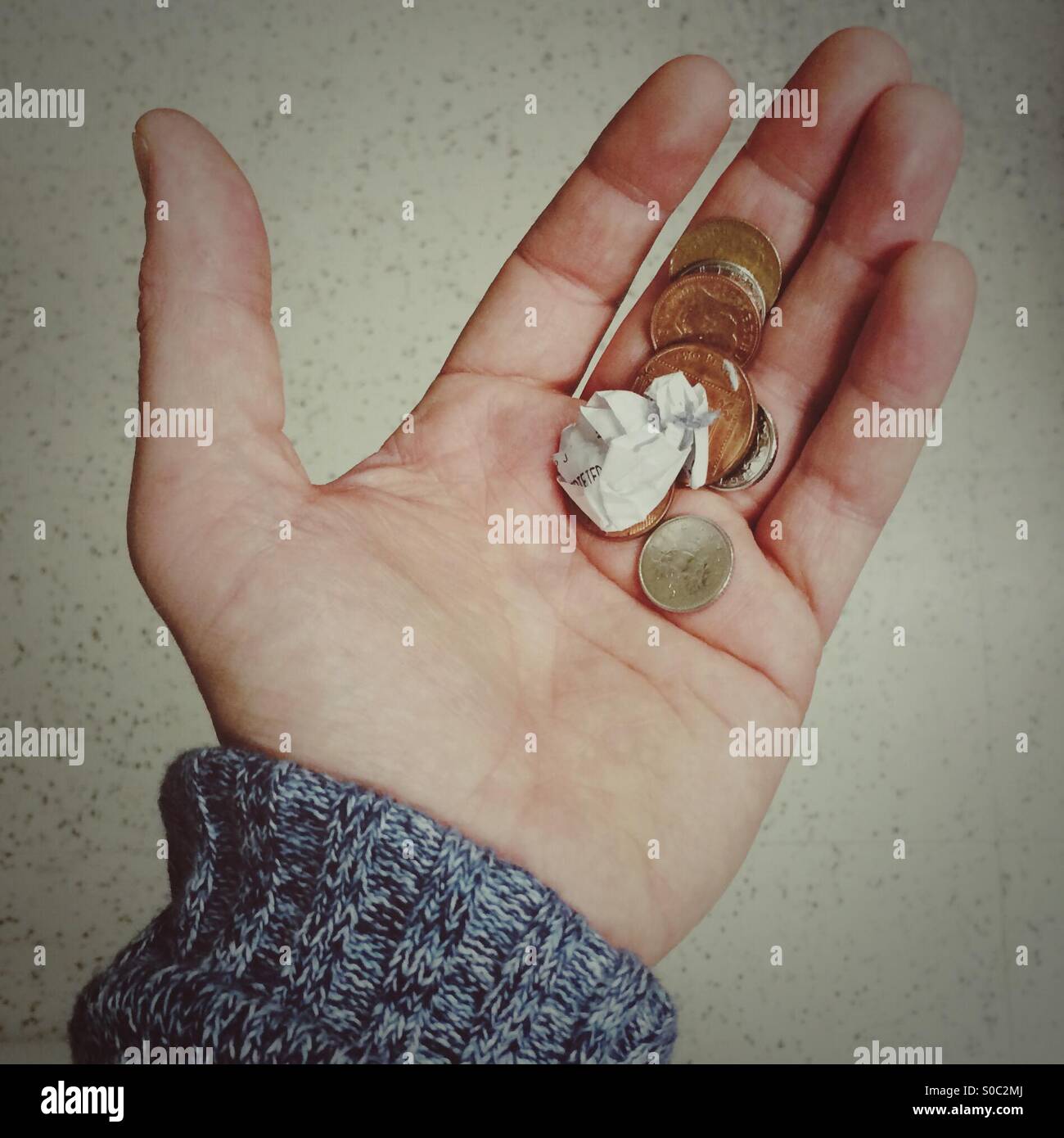 Small change and rubbish in a male hand Stock Photo - Alamy