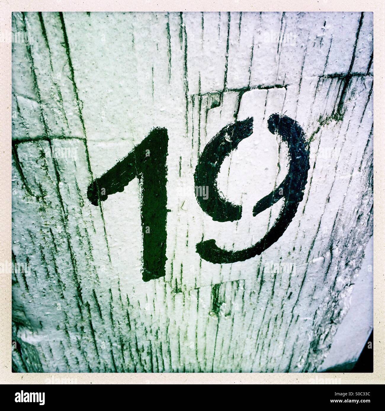 Number 19 painted in wood Stock Photo - Alamy
