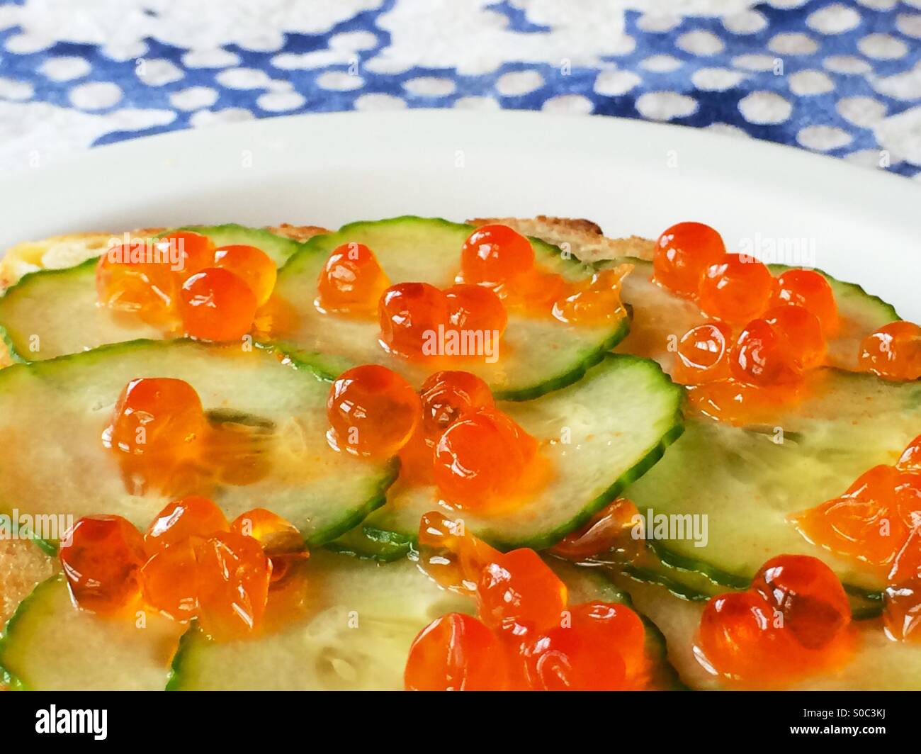 Toast with butter, cucumber and salmon roe Stock Photo - Alamy