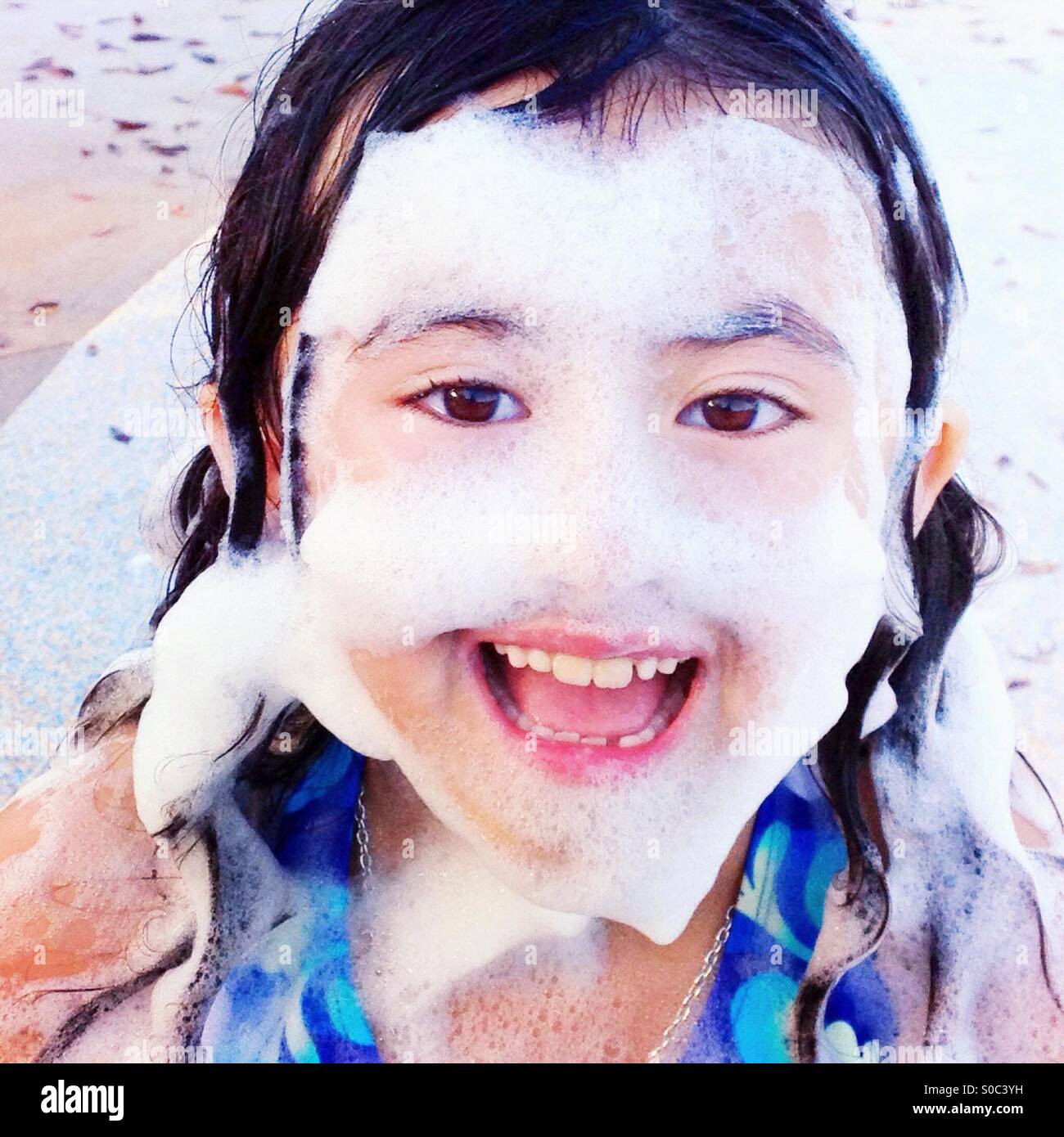 Little girl covered in bubbles at a water park Stock Photo - Alamy