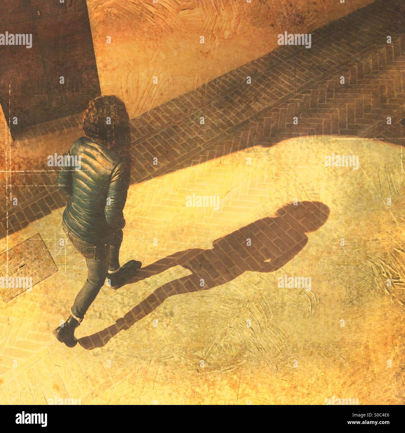Walking girl and her shadow Stock Photo - Alamy