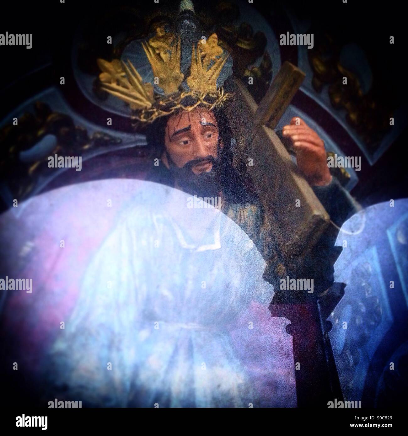 A Jesus Christ carrying the cross with the reflection of a column and ...