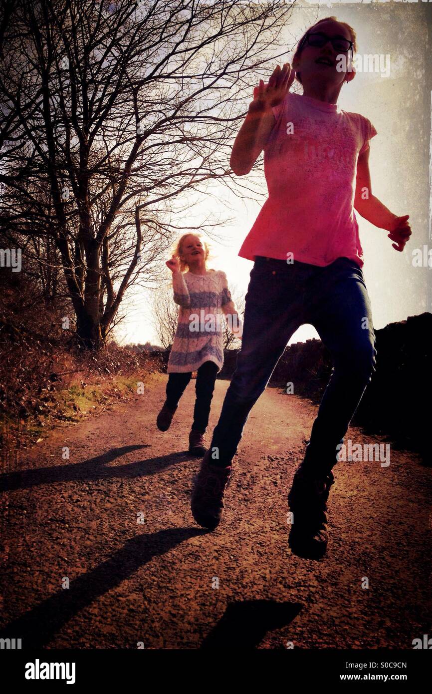 Two young children playing chase Stock Photo - Alamy