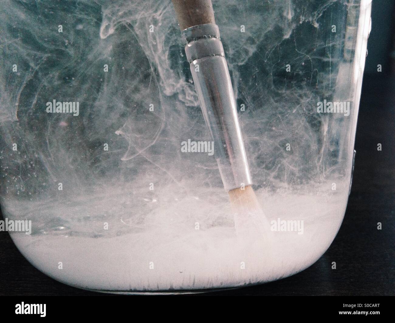 Paintbrush in water Stock Photo - Alamy