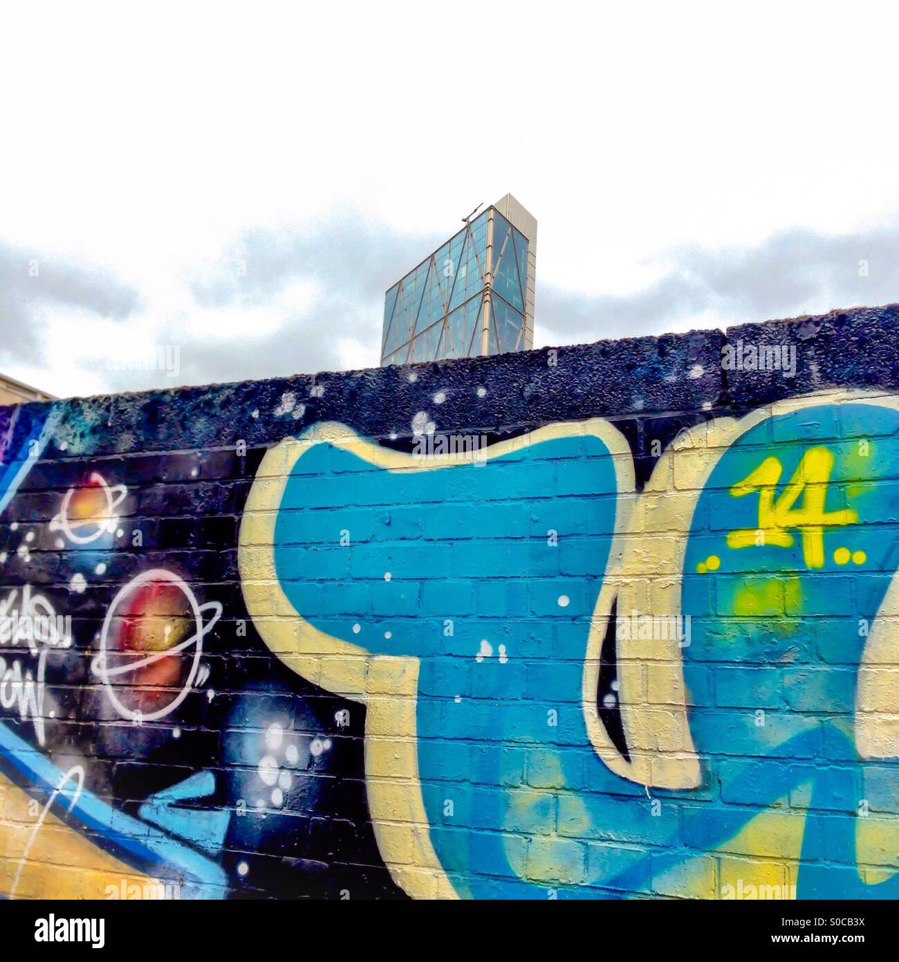 Graffiti wall with high rise Stock Photo - Alamy