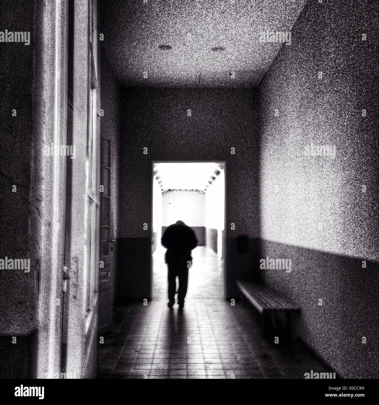 Old man in corridor from back Stock Photo - Alamy