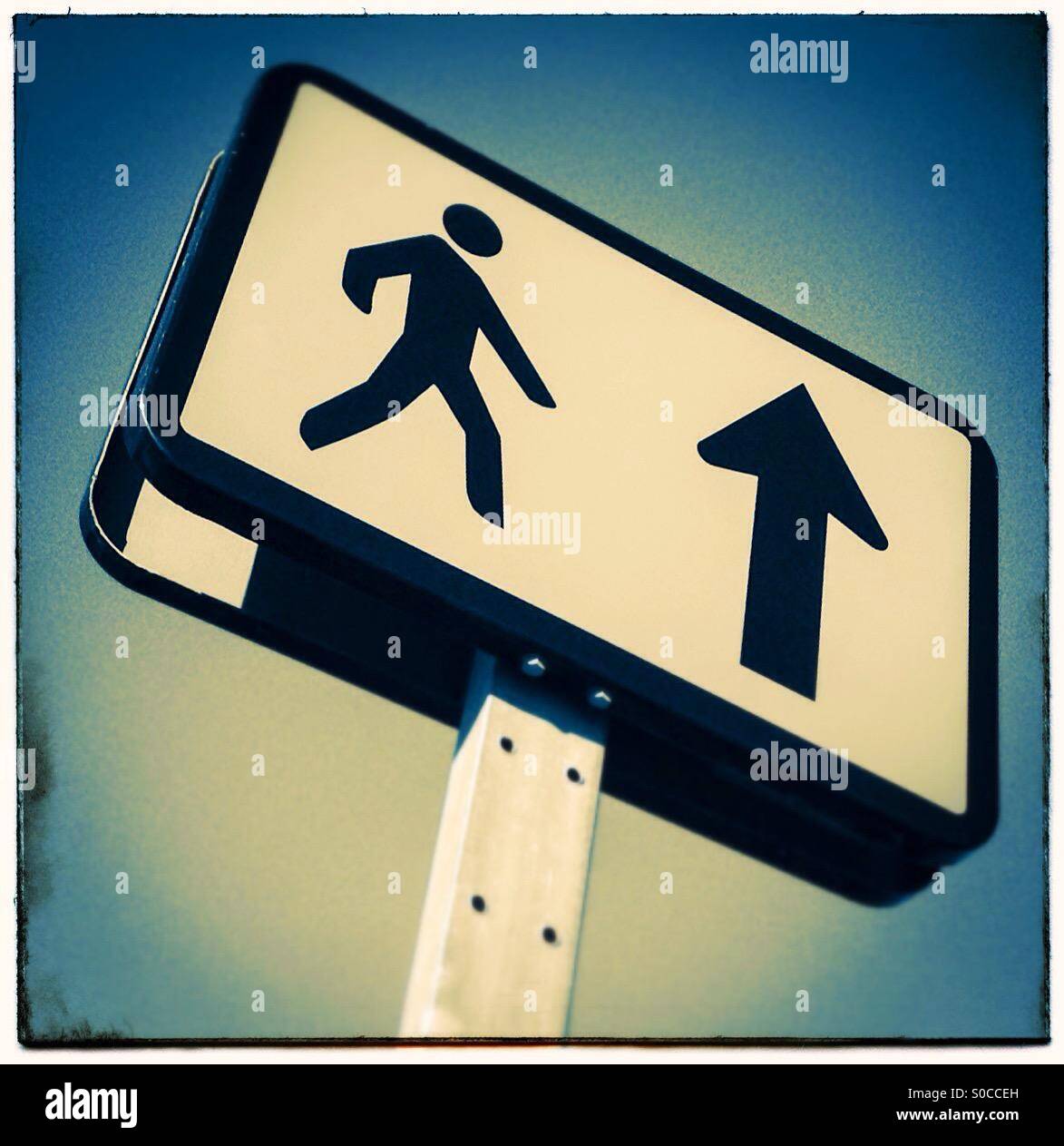 Pedestrian go ahead traffic sign on blue sky Stock Photo - Alamy