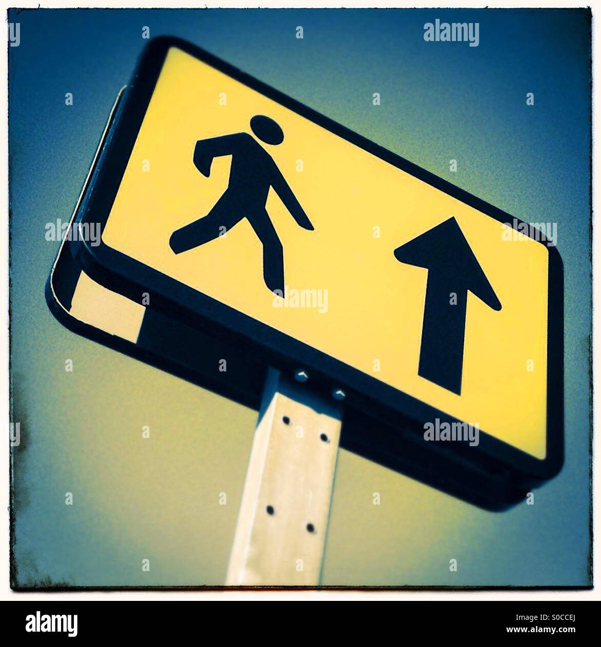 Pedestrian go ahead traffic sign on blue sky Stock Photo - Alamy