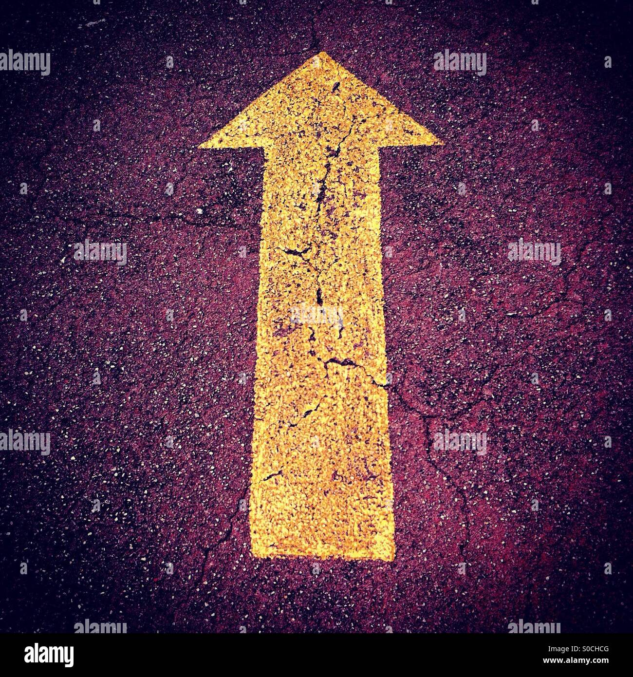 Yellow arrow showing up or straigh ahead Stock Photo - Alamy