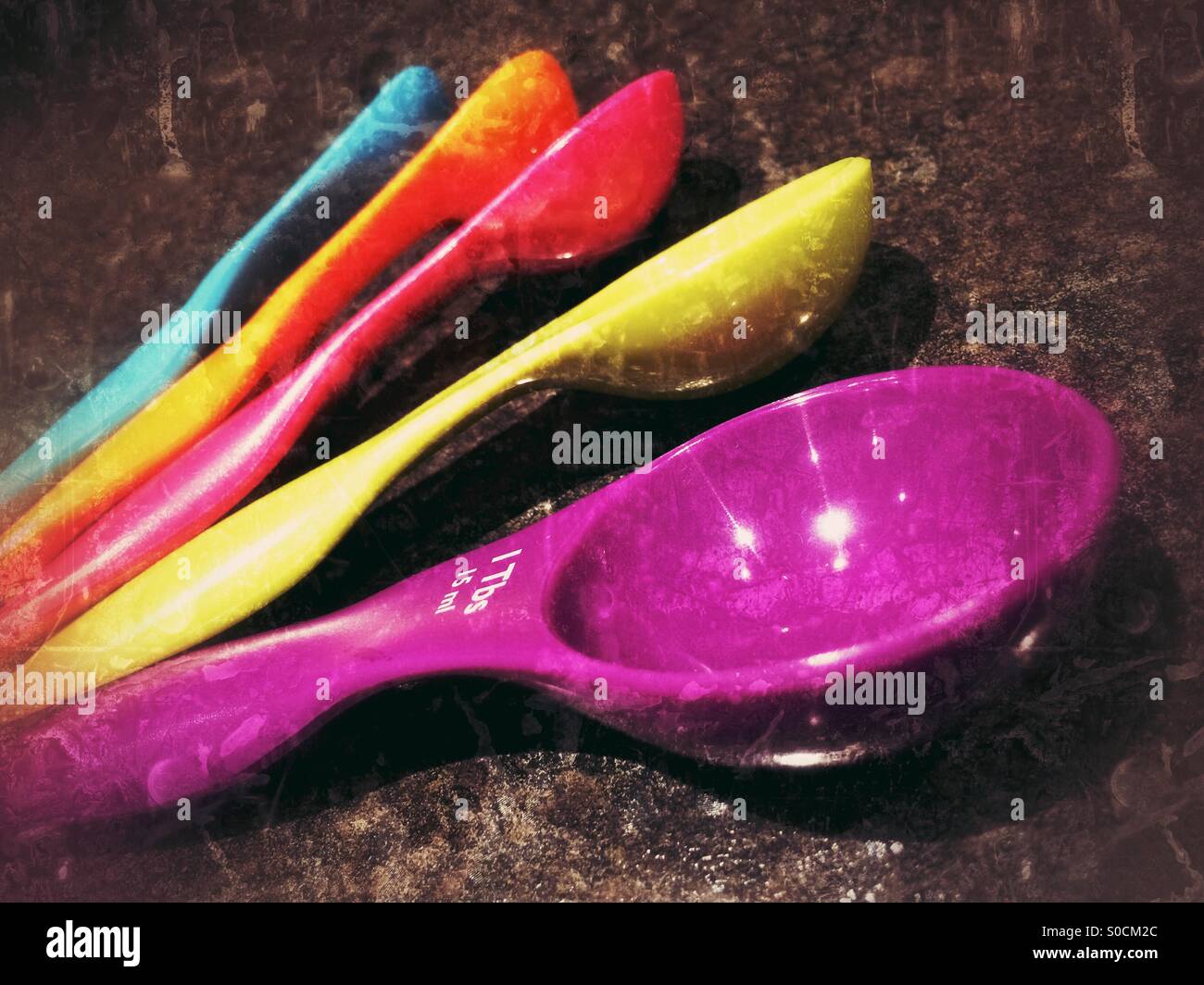Collection of coloured measuring spoons Stock Photo - Alamy