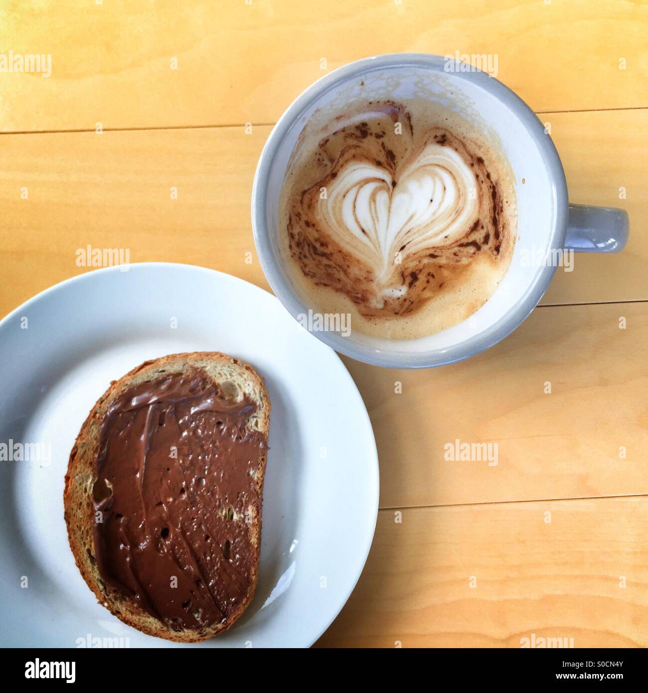 Hazelnut Spread on Toast and a Latte Stock Photo - Alamy