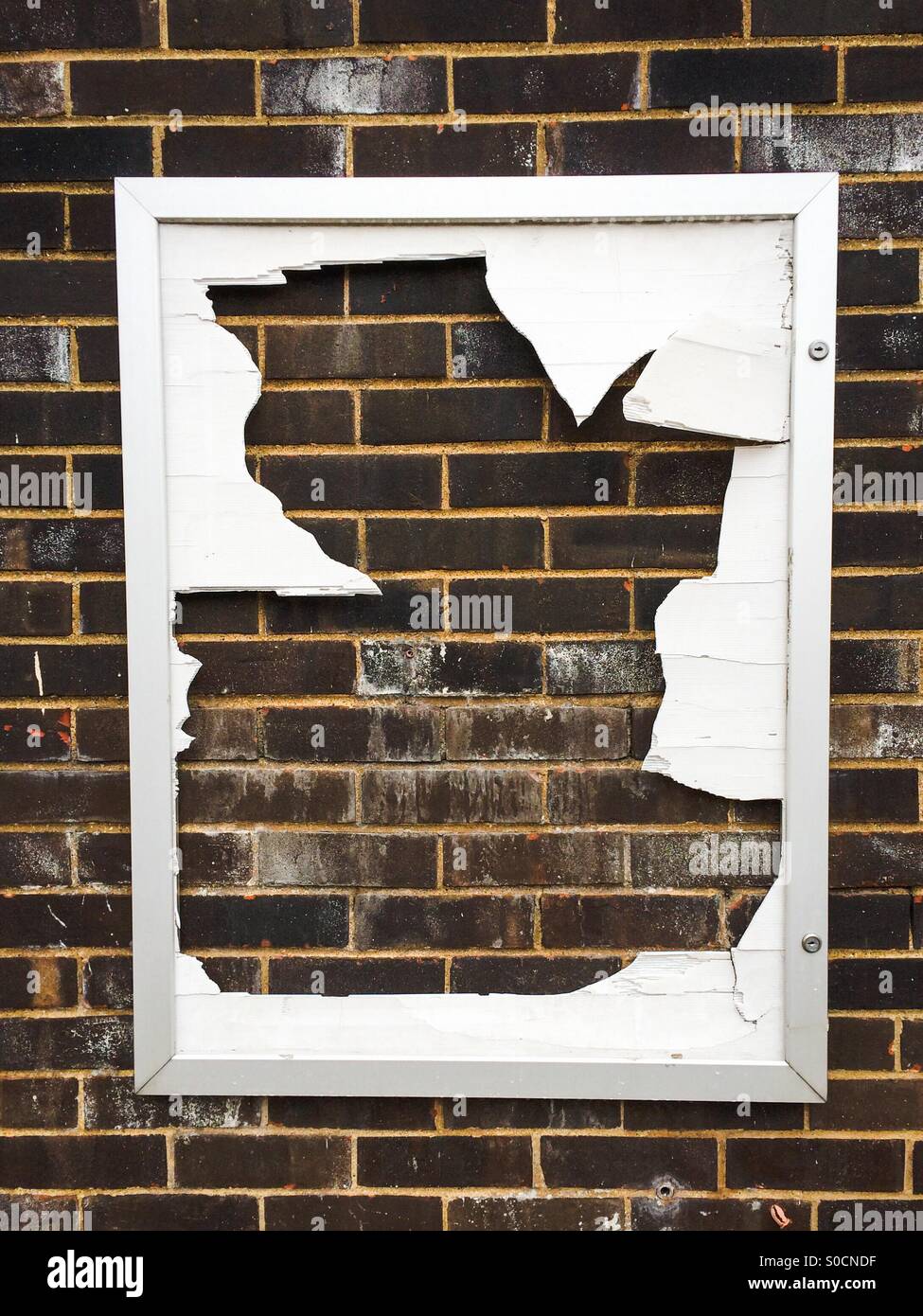 Broken frame on a brick wall Stock Photo - Alamy